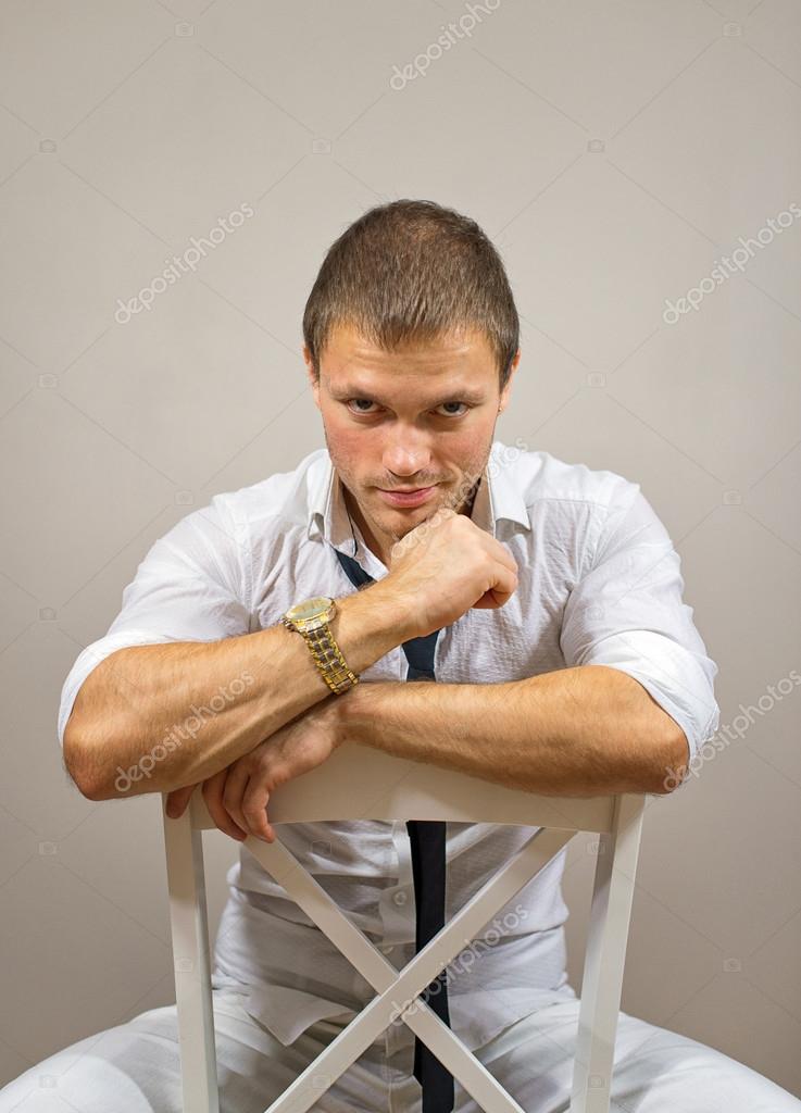 Handsome male model sitting on the chair. Stock Photo by ©mproduction ...