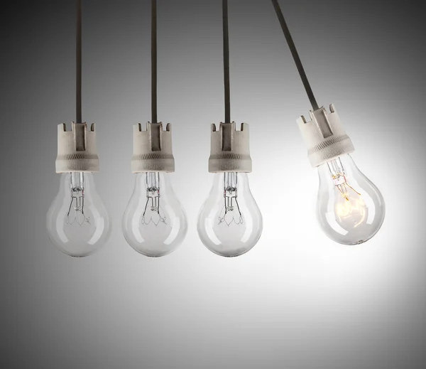 Light bulbs in row with single one shinning Stock Photo by ©jag_cz 70219359
