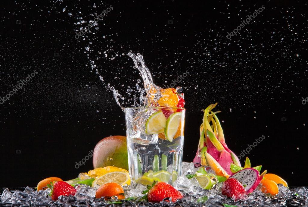 Exotic drink with splash on black background Stock Photo by ©jag_cz ...