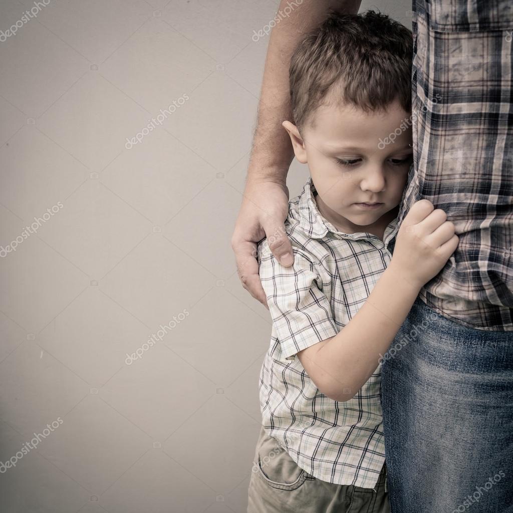 Sad son hugging his dad Stock Photo by ©altanaka 81459572