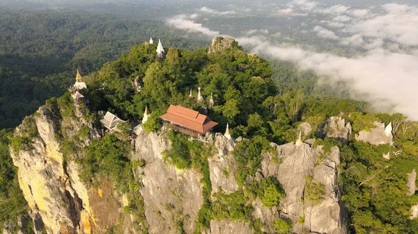 Aerial view of Wat Phra Bat Phu Pha Daeng and white pagodas on top peak ...