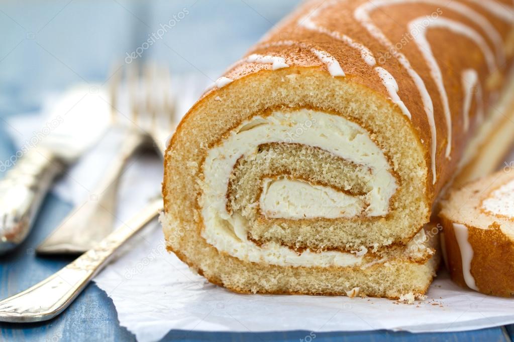 Sweet roll in white paper on blue background Stock Photo by ...