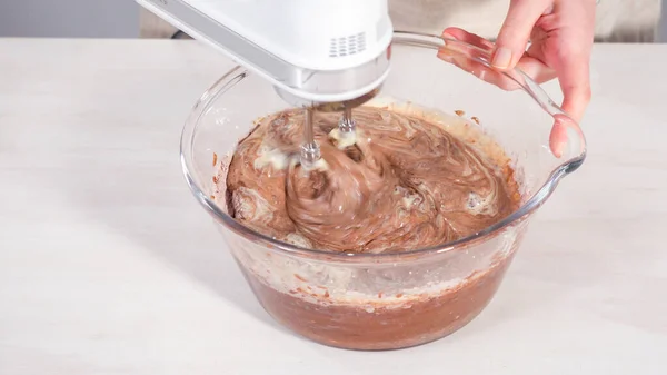 Step by step. Mixing ingredients in a glass mixing bowl to bake ...