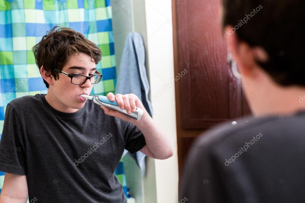 Teenage boy brushing teeth Stock Photo by ©urban_light 72479399