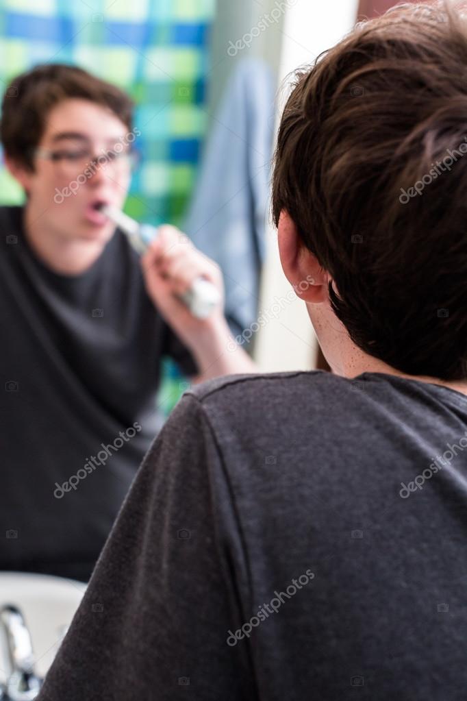 Teenage boy brushing teeth Stock Photo by ©urban_light 72479467
