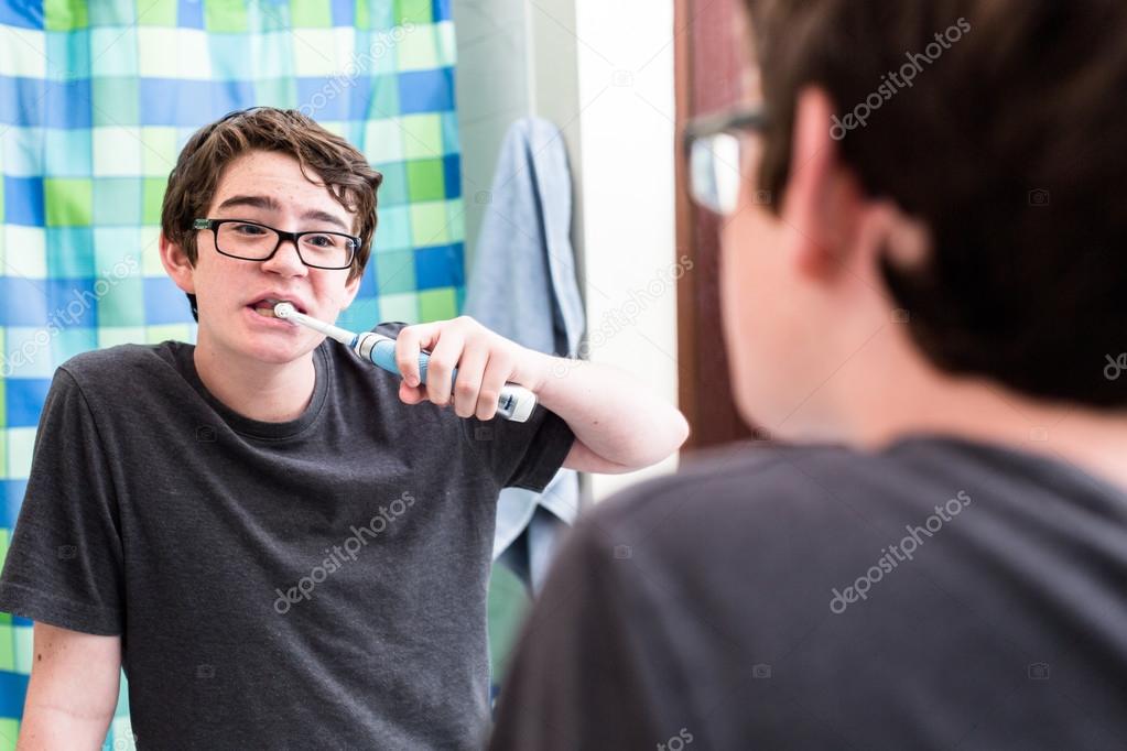 Teenage boy brushing teeth Stock Photo by ©urban_light 72479481
