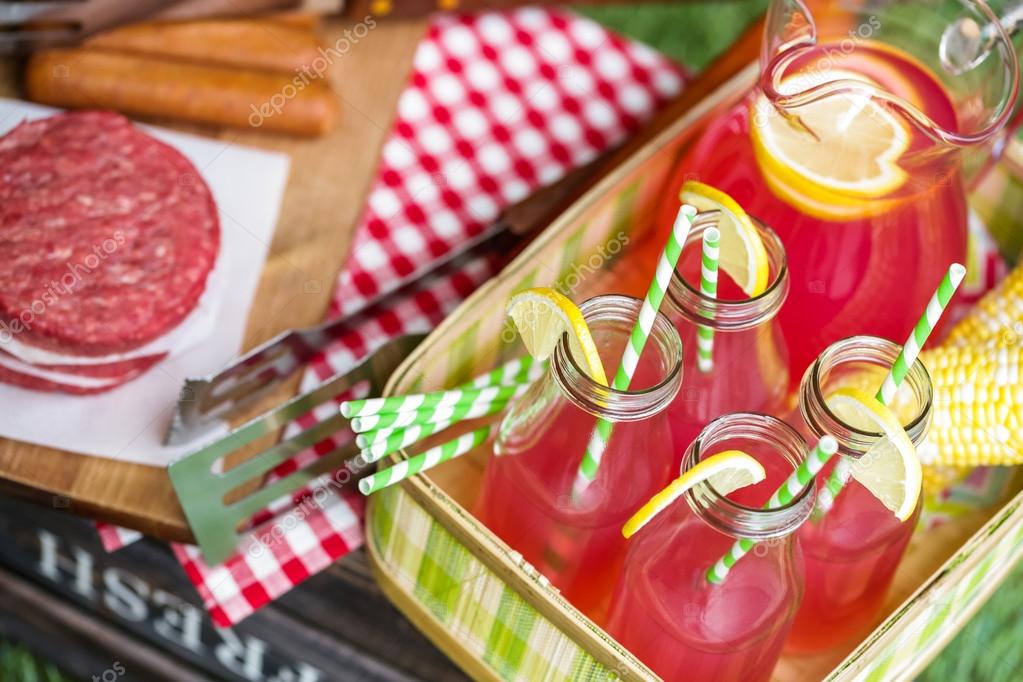 Summer picnic with lemonade and hamburger patties — Stock Photo © urban ...