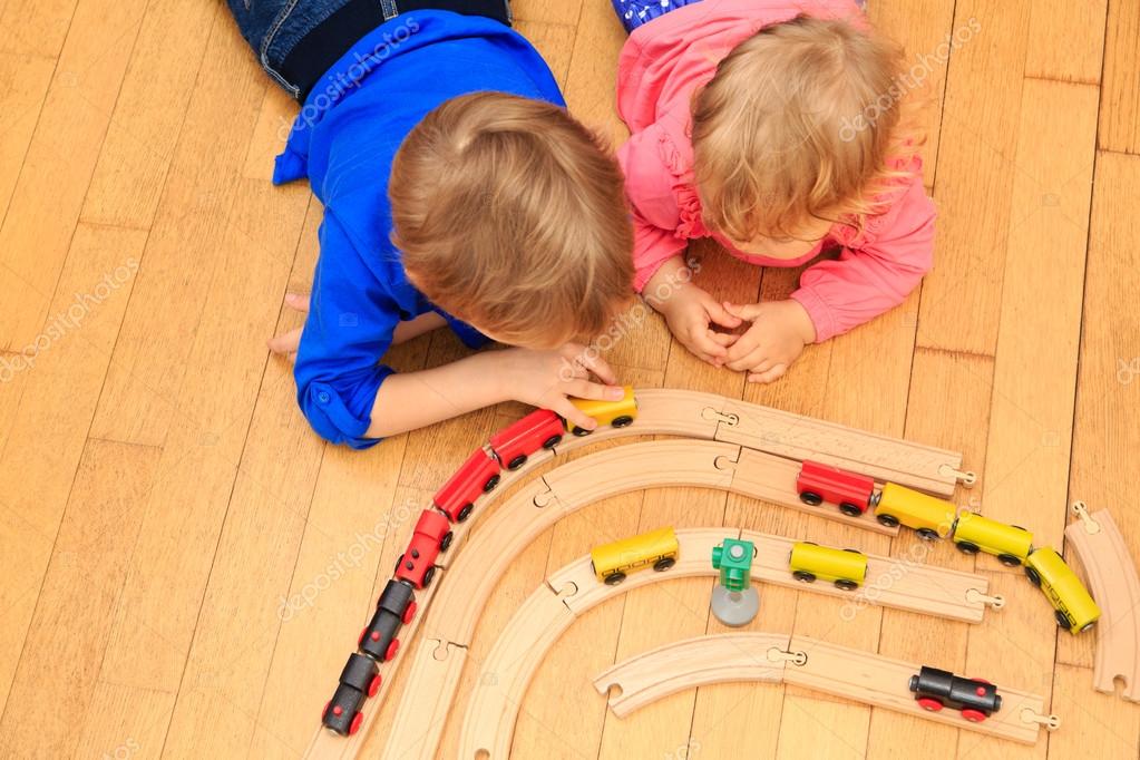 Kids playing with railroad and trains indoor Stock Photo by ...