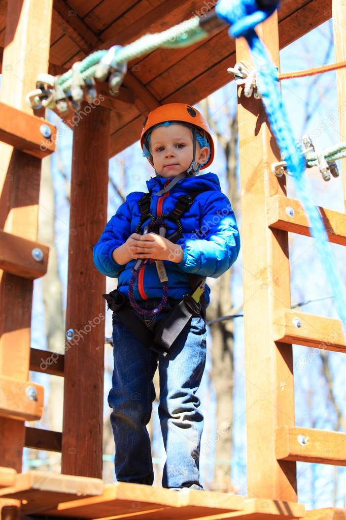Little boy climbing in adventure activity park — Stock Photo ...