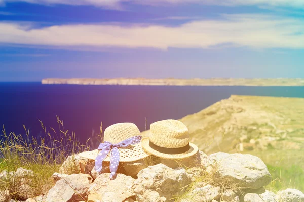 two hats on vacation in mountains at the sea - Stock Image - Everypixel