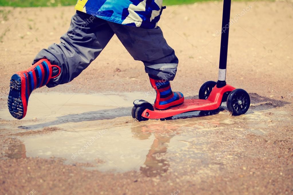 Child playing in water puddle, kids outdoors Stock Photo by ...