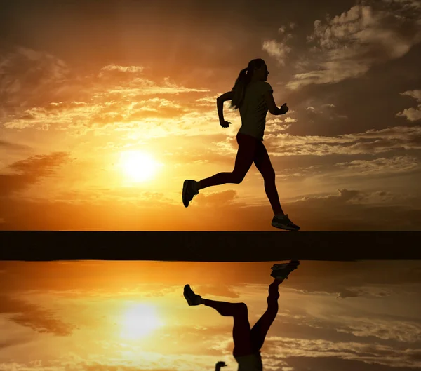 Female runner silhouette, running into sunset — Stock Photo ...