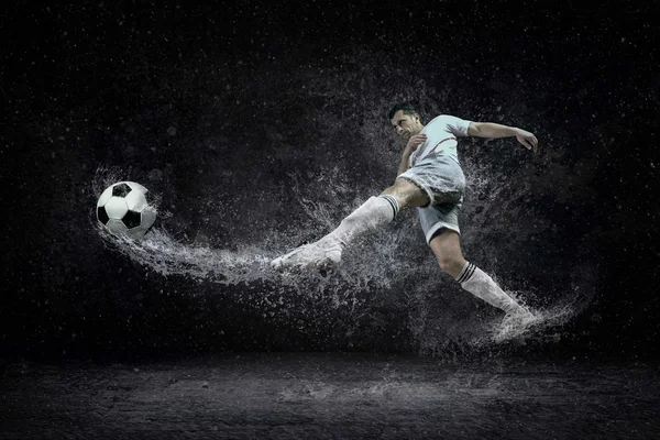Splash of drops around football player - Stock Image - Everypixel