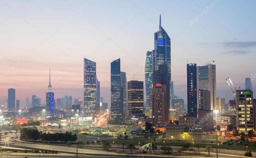 Skyscrapers downtown in Kuwait City illuminated at dusk. December 10 ...
