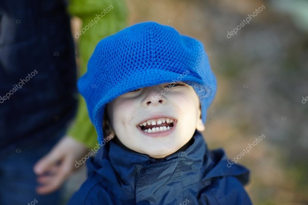 Funny little boy in blue hat Stock Photo by ©Gladkov 52973861