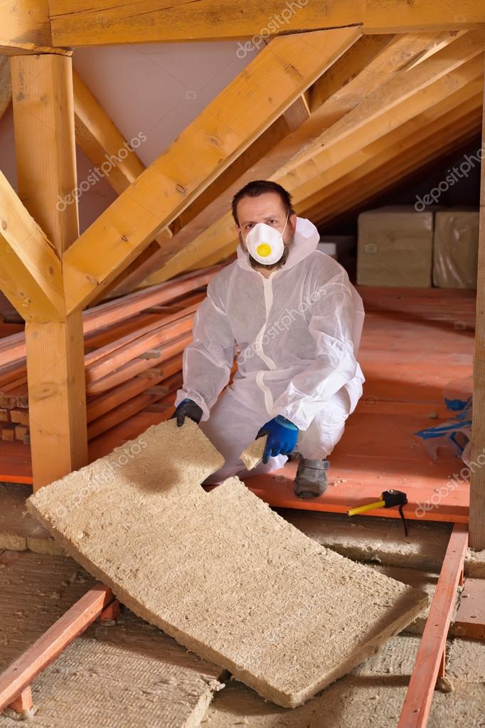 Man laying thermal insulation layer Stock Photo by ©lightkeeper 60188077