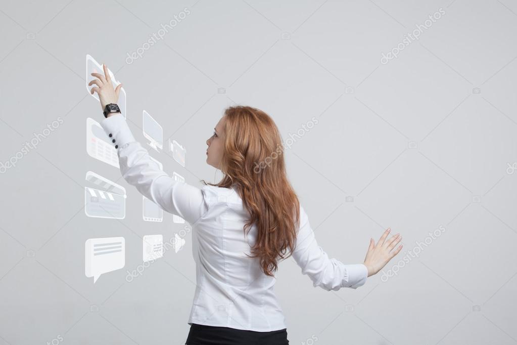 Woman pressing high tech type of modern multimedia buttons on a virtual ...