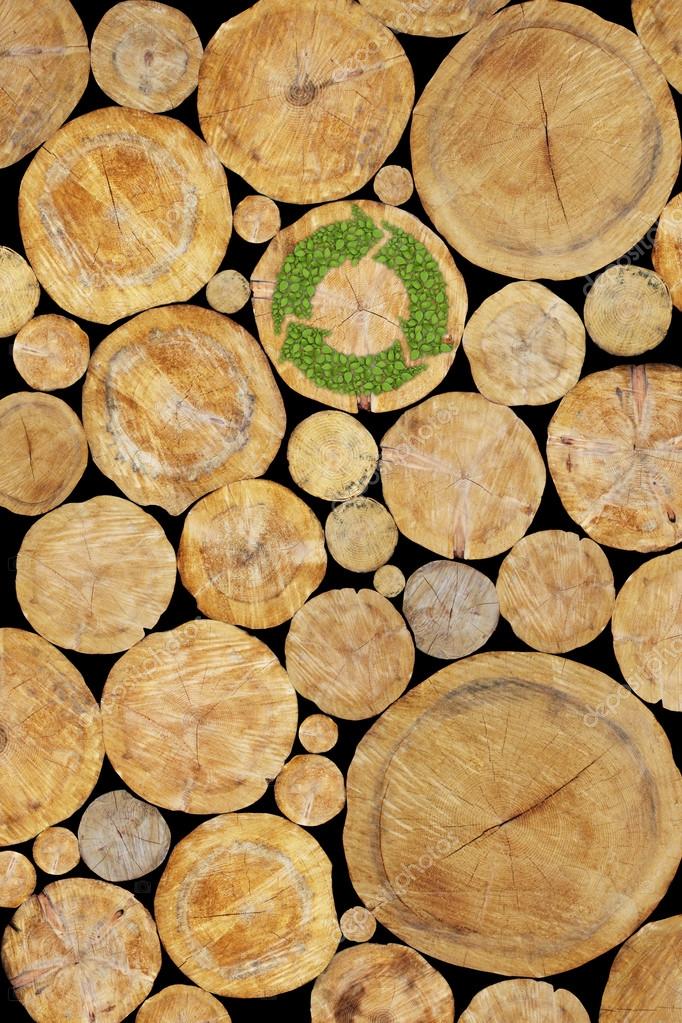 Stacked Logs Background with green plant recycle symbol Stock Photo by ...