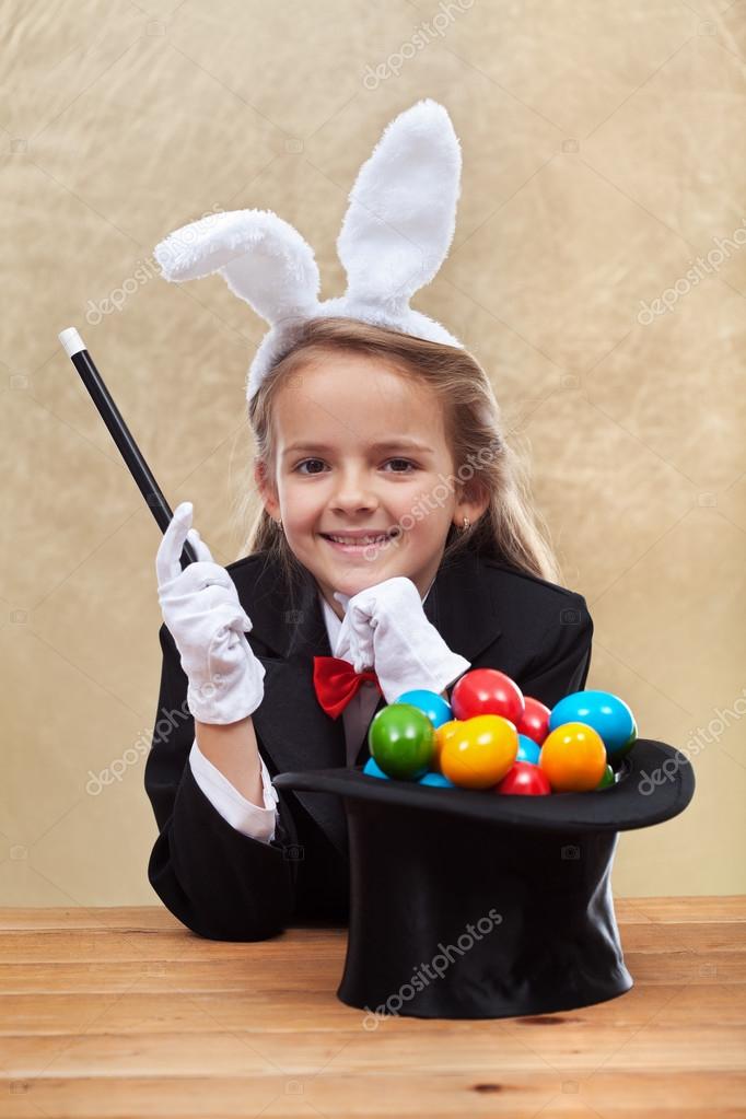 Happy magician girl making easter eggs with her powers Stock Photo by ...