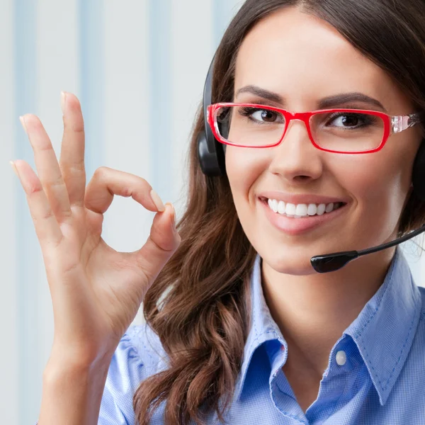 Support phone operator in headset, showing okay gesture - Stock Image ...
