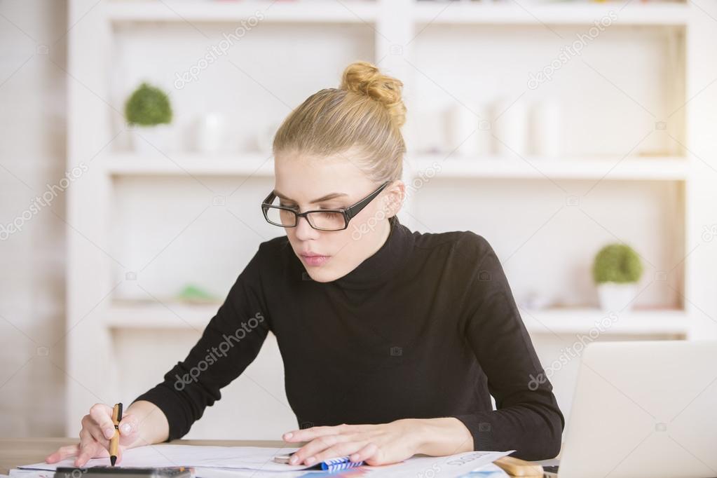 Attractive female accountant at work Stock Photo by ©peshkova 122524590
