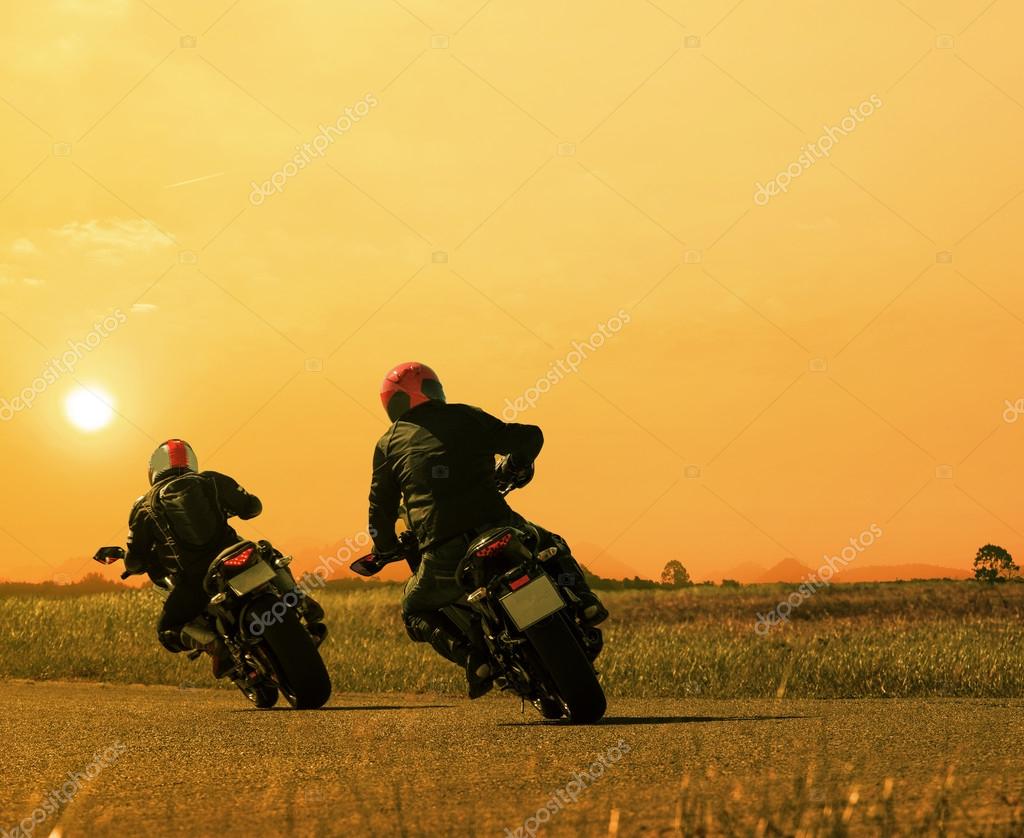 Couples friend motorcycle rider biking on asphalt highway agains ...