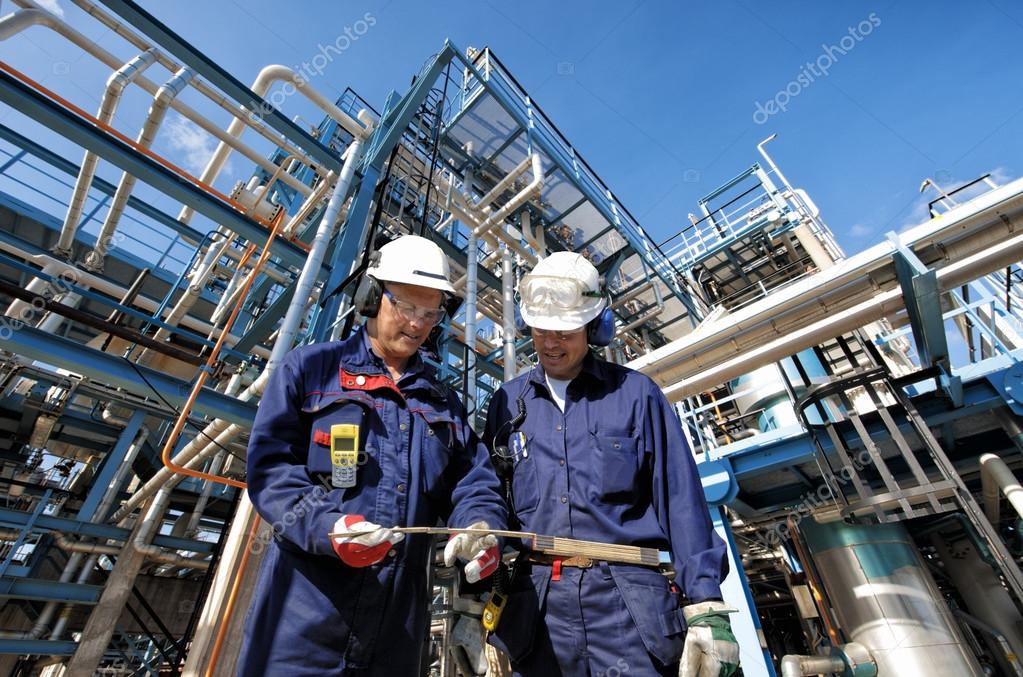 Oil and gas workers inside refinery — Stock Photo © lagereek #87610456