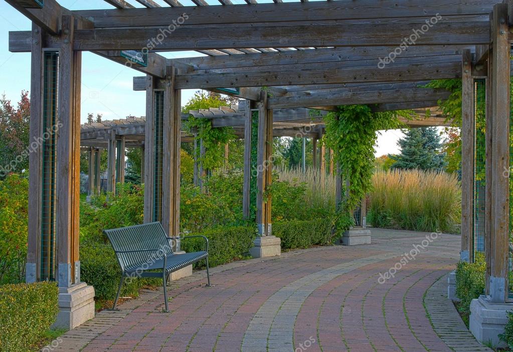 Bench under under a shaded arbor in Toronto park. Stock Photo by ...
