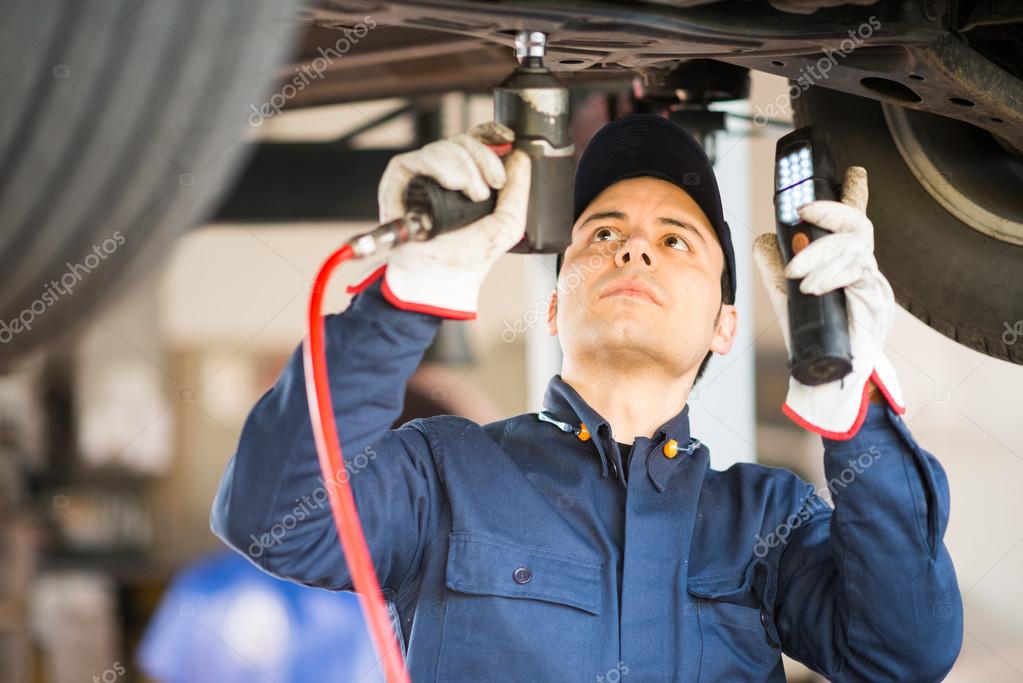 Mechanic repairing car — Stock Photo © minervastock #109111234