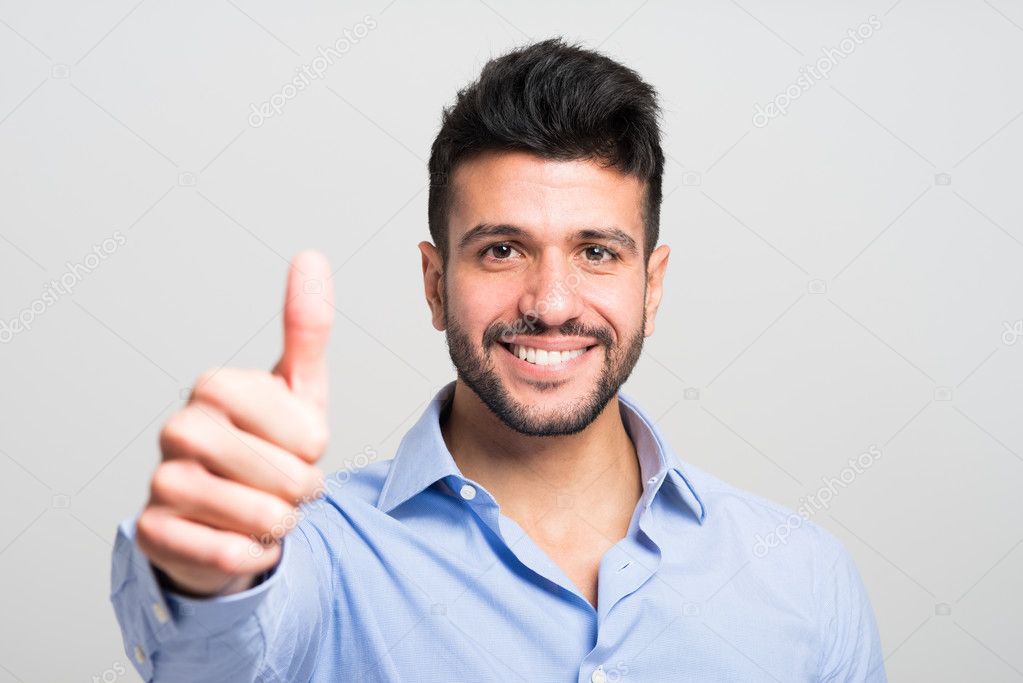 Smiling man giving thumbs up Stock Photo by ©minervastock 112288328