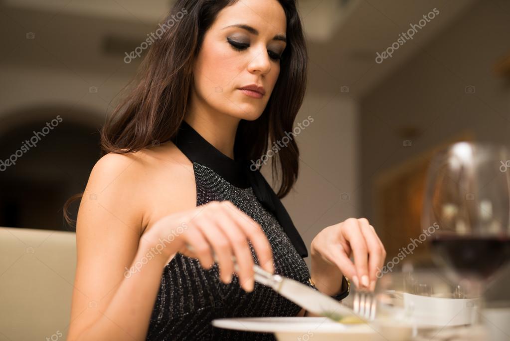 Woman eating in restaurant Stock Photo by ©minervastock 122362280