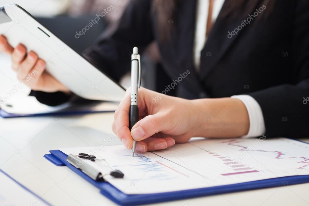 Woman taking notes during meeting Stock Photo by ©minervastock 55960927