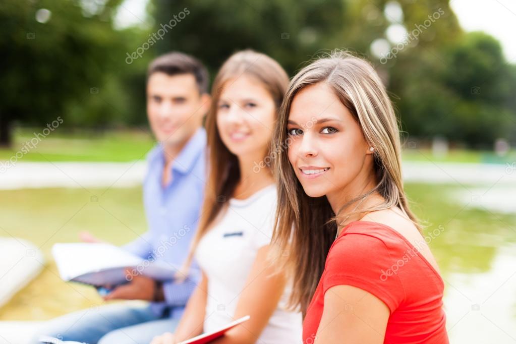 Three students studying in a park Stock Photo by ©minervastock 67629887