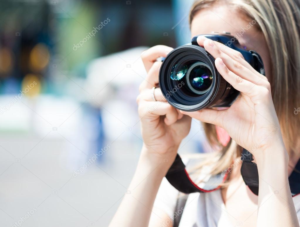 Female photographer using digital camera — Stock Photo © minervastock ...