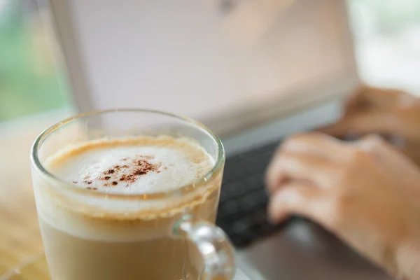 Closeup of coffee and hand typing on laptop keyboard - Stock Image ...