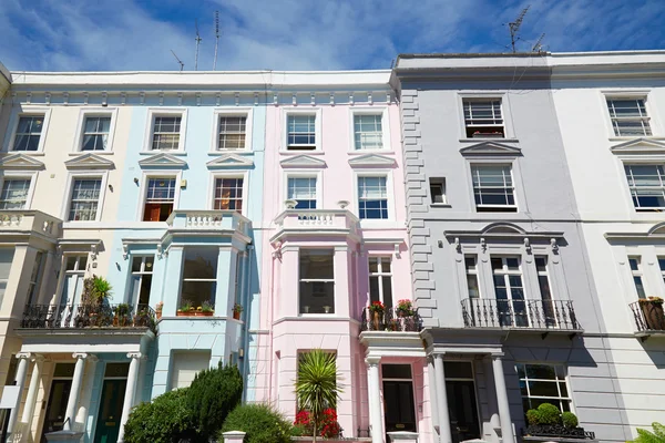 Colorful English houses facades in London, blue sky in a sunny day ...
