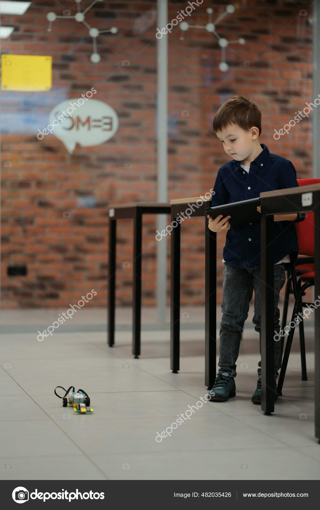 Little kid boy having fun while driving a robot car — Stock Photo ...