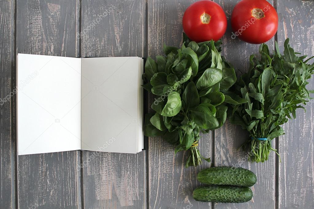 Note book and composition of vegetables on grey wooden desk. Stock ...