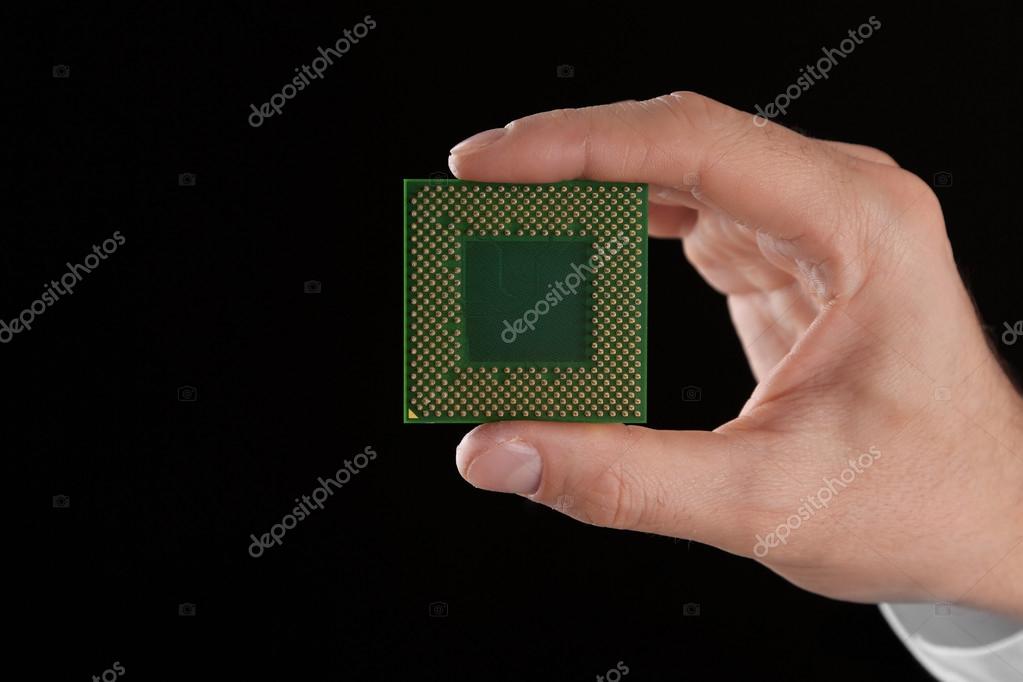 Hand holding microprocessor — Stock Photo © belchonock #100440540