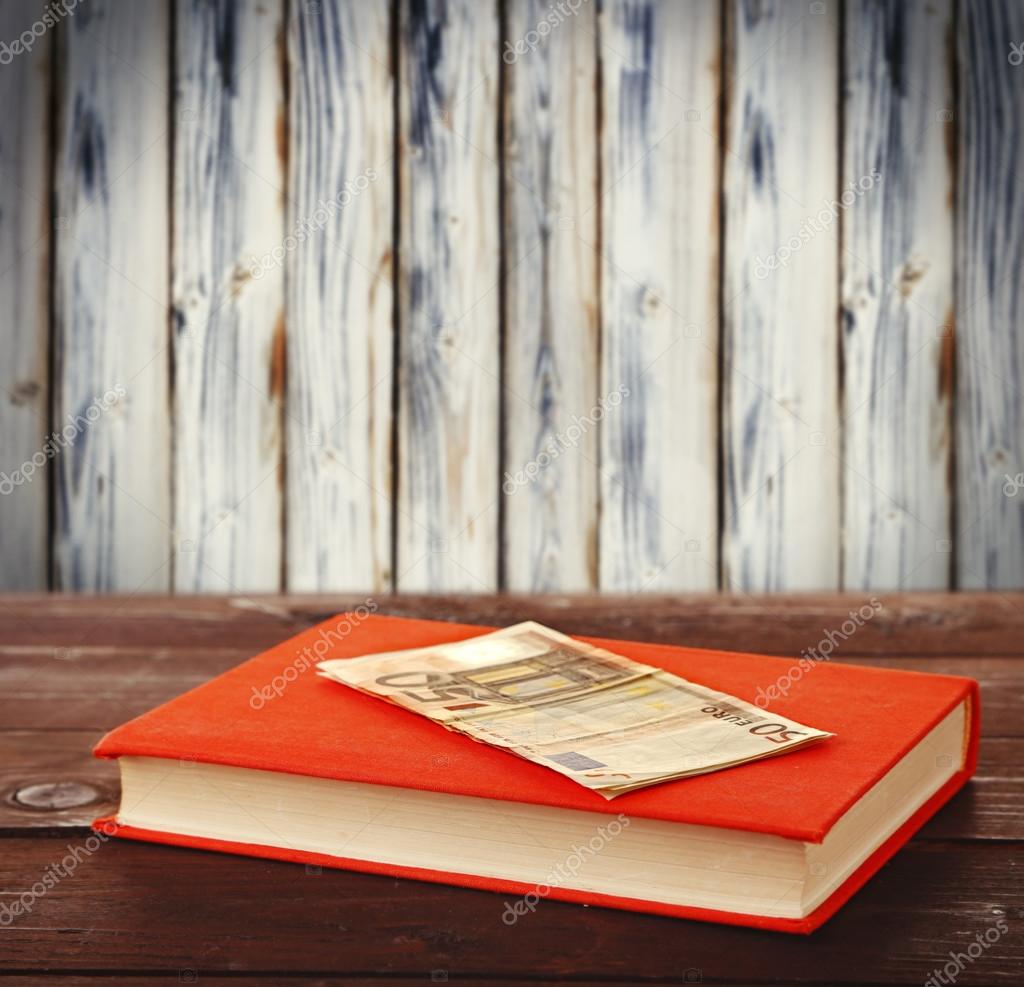 Red book with euro banknotes Stock Photo by ©belchonock 104969942