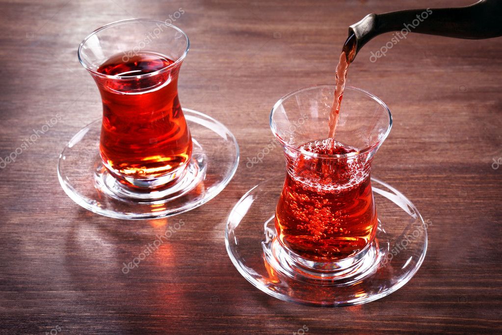 Pouring black tea into glass cups on wooden table Stock Photo by ...