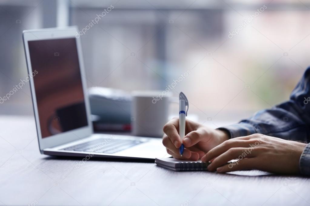 Hands taking notes and using laptop Stock Photo by ©belchonock 106720968