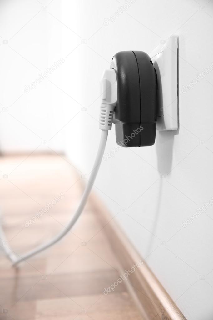 Electric plug in socket Stock Photo by ©belchonock 109714080