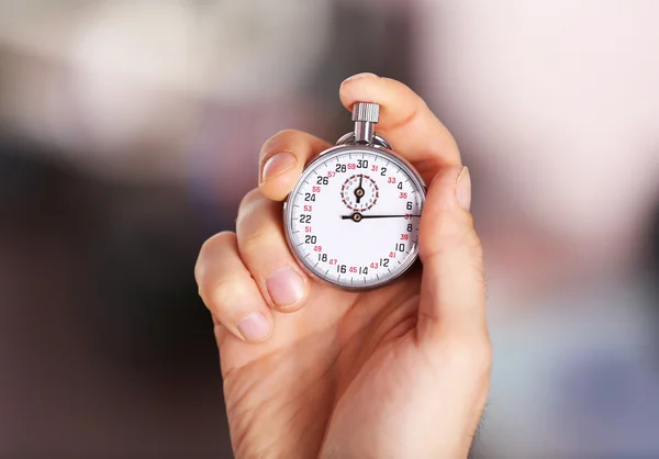 Human hand holding stopwatch — Stock Photo © Rangizzz #9570274