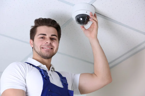 Professional CCTV technician working. Stock Photo by ©belchonock 112223670