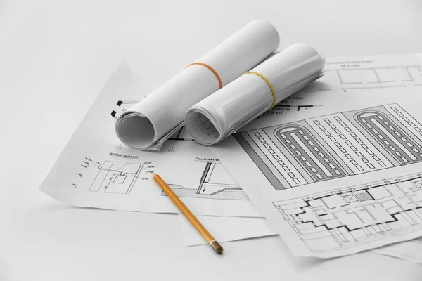 Architecture blueprints on table Stock Photo by ©belchonock 113531588