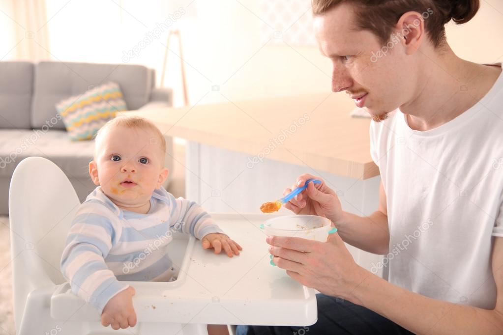 Father feeding son — Stock Photo © belchonock #111464442