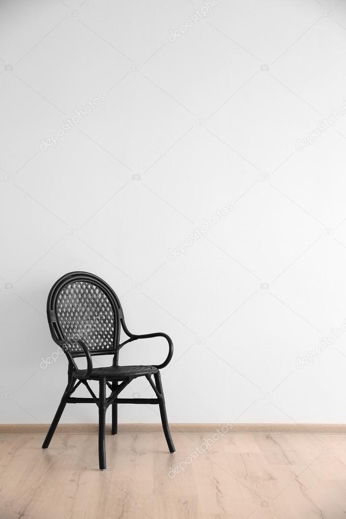 Chair on wall background Stock Photo by ©belchonock 113531144