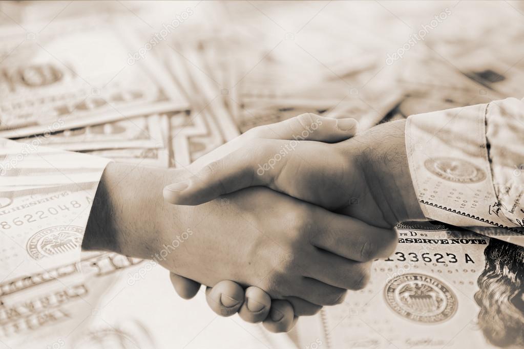 Handshake on finance background. Stock Photo by ©belchonock 115403040