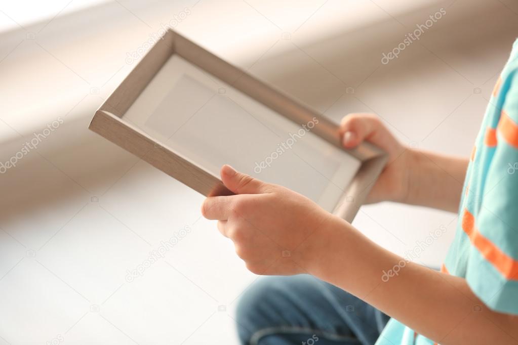 Hands holding photo frame — Stock Photo © belchonock #116577710